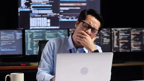 Asian Male Programmer Yawning While Writ... | Stock Video | Pond5