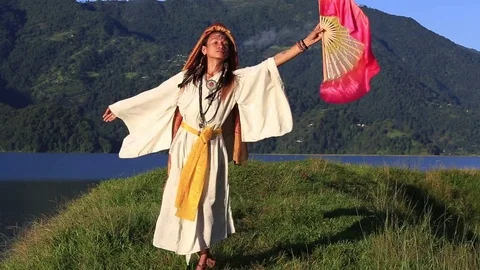 Asian man dancing with a fan at sunrise ... | Stock Video | Pond5