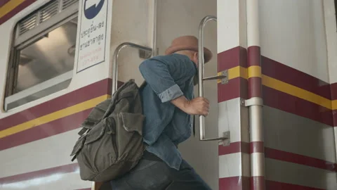 Asian man grabbing the train railing for... | Stock Video | Pond5