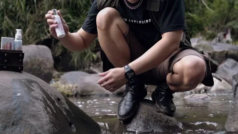 an Asian man is washing his face with ri... | Stock Video | Pond5