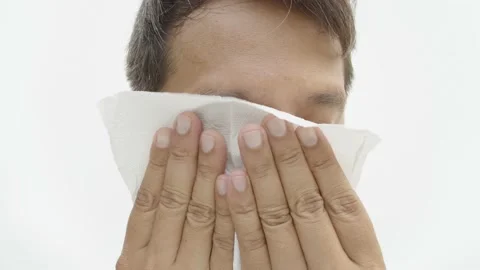 Asian man wiping his face with tissue pa... | Stock Video | Pond5