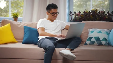 Asian man work on laptop at home. Korean... | Stock Video | Pond5