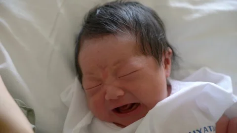 Asian newborn baby crying beside her mot... | Stock Video | Pond5
