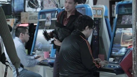 Asian people playing arcade machine game... | Stock Video | Pond5