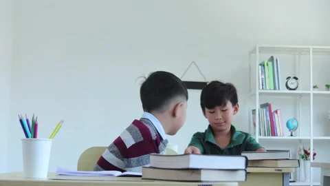 An Asian school boy giving a pencil to h... | Stock Video | Pond5