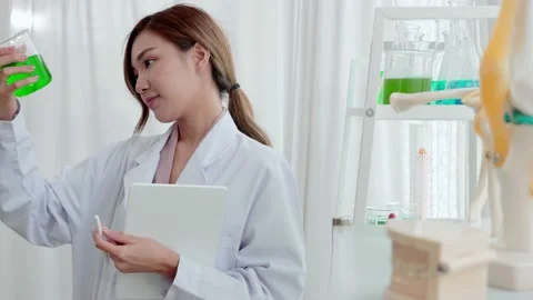 Asian Scientist in the laboratory. Physi... | Stock Video | Pond5