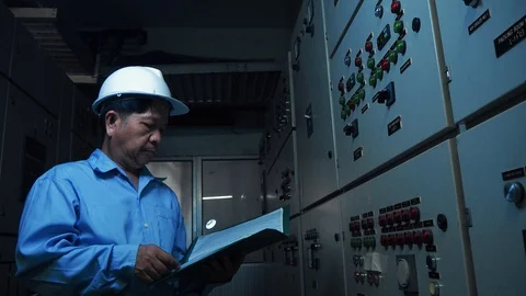 An asian senior engineer reading manual ... | Stock Video | Pond5