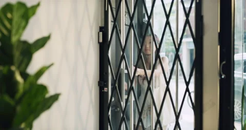 Asian store owner opening locked door to... | Stock Video | Pond5