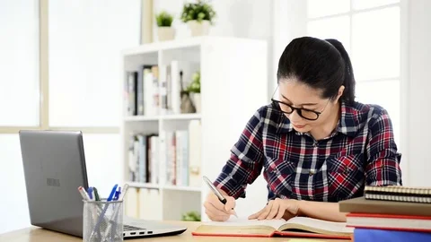 Asian student finish her homework | Stock Video | Pond5