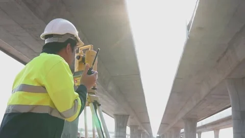 Asian surveyor diligently at road constr... | Stock Video | Pond5