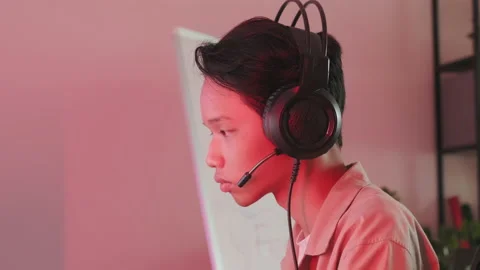 Asian Teen Boy Gaming in Room with Neon ... | Stock Video | Pond5