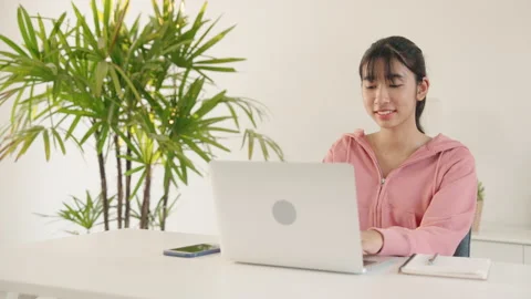 Asian teen girl typing work on laptop. | Stock Video | Pond5
