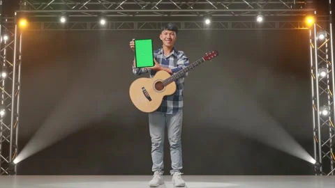Asian Teenager With Guitar Smiling And S... | Stock Video | Pond5