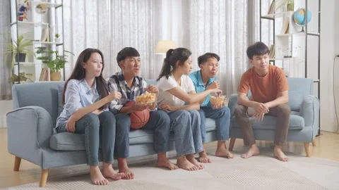 Asian Teenagers Cheering, Eating And Wat... | Stock Video | Pond5