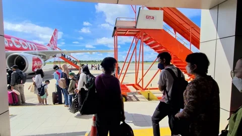 Asian travelers standing in a queue on r... | Stock Video | Pond5