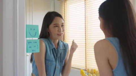 Asian woman self talk in front of mirror... | Stock Video | Pond5