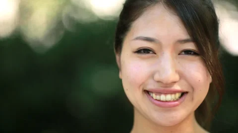 Asian woman serious smiling face sitting... | Stock Video | Pond5