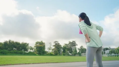 asian woman standing on the running trac... | Stock Video | Pond5