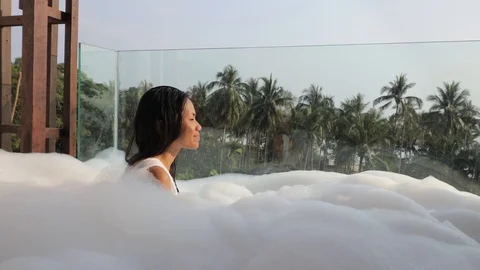 An asian woman taking a bubble bath in a... | Stock Video | Pond5