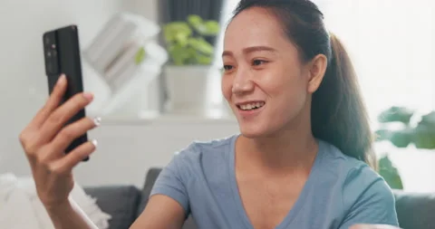 Asian woman use smartphone raise hand vi... | Stock Video | Pond5