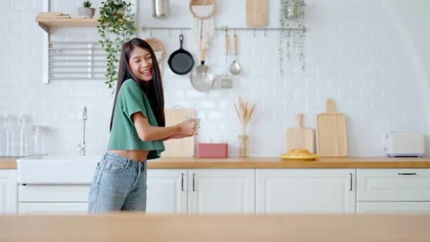 Asian young woman dancing in kitchen roo... | Stock Video | Pond5
