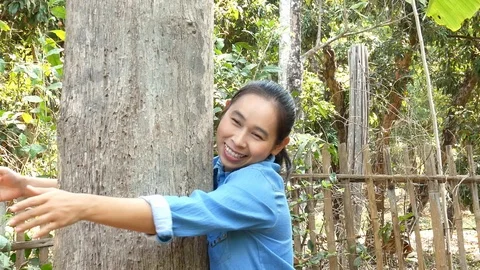 Asian young woman hugging a big tree wit... | Stock Video | Pond5