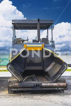 Asphalt laying machine close-up. A paver finisher Stock Image #194490181