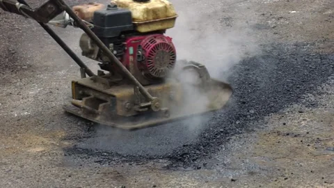Asphalt vibratory plate compactor. Potho... | Stock Video | Pond5