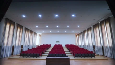 Assembly hall, red chairs, white ceiling | Stock Video | Pond5