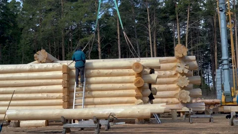 Assembly of a Wooden Log House at a Cons... | Stock Video | Pond5