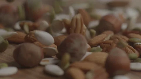 Assorted Nuts Falling On Wood Surface | Stock Video | Pond5