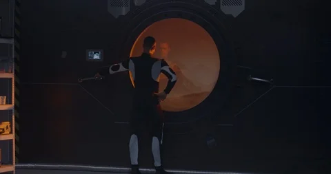 Astronaut looking out window of Mars bas... | Stock Video | Pond5