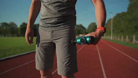 An athlete massages with a percussion th... | Stock Video | Pond5