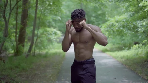 An athlete shadow boxes outside in the w... | Stock Video | Pond5