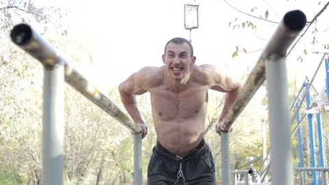 Athlete is squeezed out on two bars. | Stock Video | Pond5