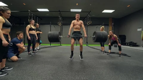 Athletes cheering man while lifting weig... | Stock Video | Pond5