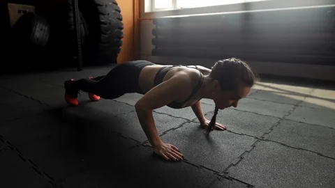 Athletic beautiful woman doing push-ups ... | Stock Video | Pond5