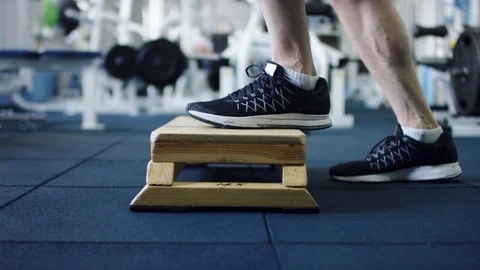 Athletic man exercises on a step board i... | Stock Video | Pond5