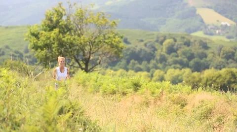 athletic woman running in countryside | Stock Video | Pond5