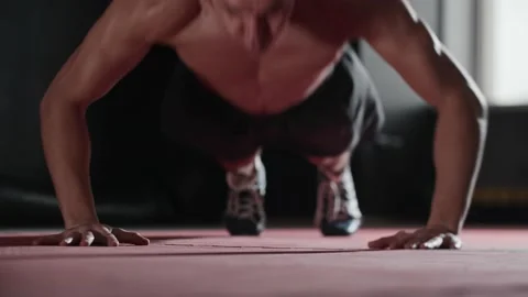 Athletic young man does low push ups wit... | Stock Video | Pond5