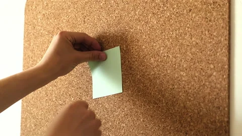 Attaching a sticker to a cork board. Sid... | Stock Video | Pond5