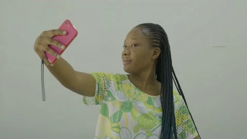 Attractive African girl with braids taki... | Stock Video | Pond5