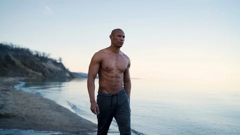 Attractive and muscular man walking alon... | Stock Video | Pond5