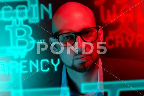 Attractive bald man with beard with glasses on neon light background ...