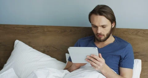 Attractive Caucasian young man scrolling... | Stock Video | Pond5