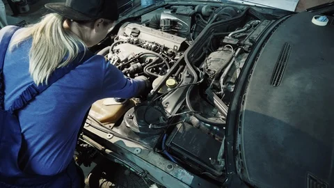 Attractive female mechanic working on ca... | Stock Video | Pond5