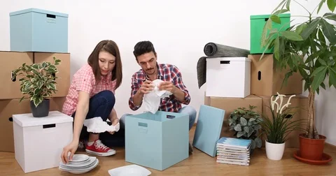 Attractive Home Couple Packing Dishes Fr... | Stock Video | Pond5