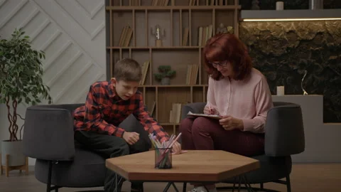 Autism therapist talking to autistic kid... | Stock Video | Pond5