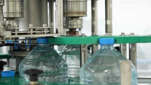 Automatic capping of plastic bottles. Dr... | Stock Video | Pond5