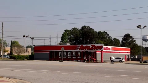 AutoZone and a person in the parking lot... | Stock Video | Pond5